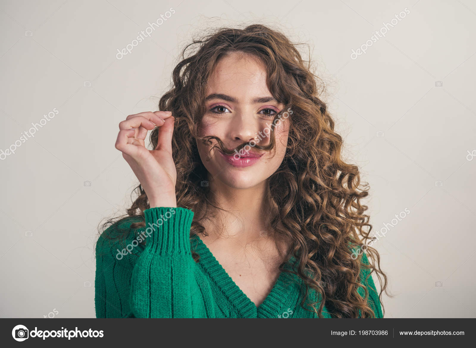 Brunette girl with long and shiny curly hair . Beautiful model woman with wavy hairstyle ...