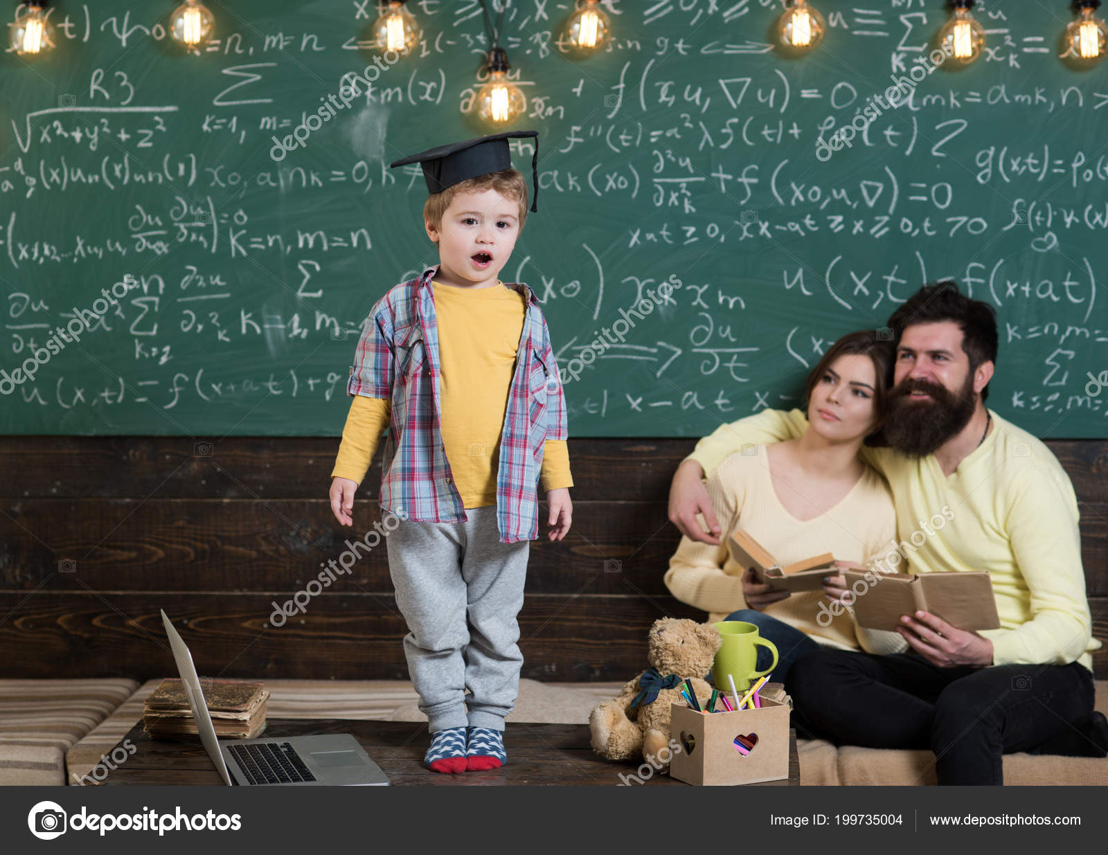 Boy presenting his knowledge to mom and dad. Smart child in graduate ...