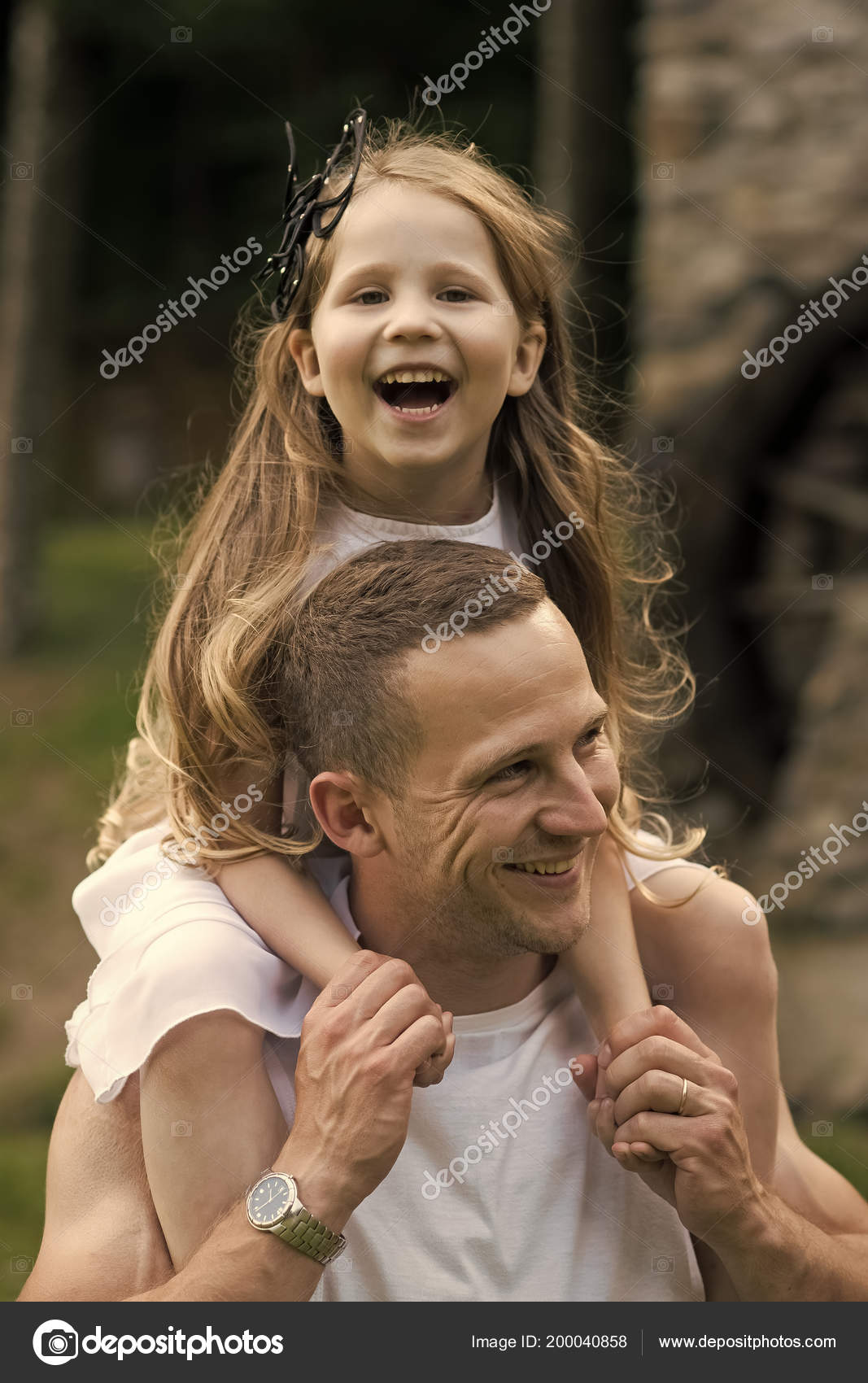 Girl on the shoulders of dad. Girl child smile on man shoulders Stock ...