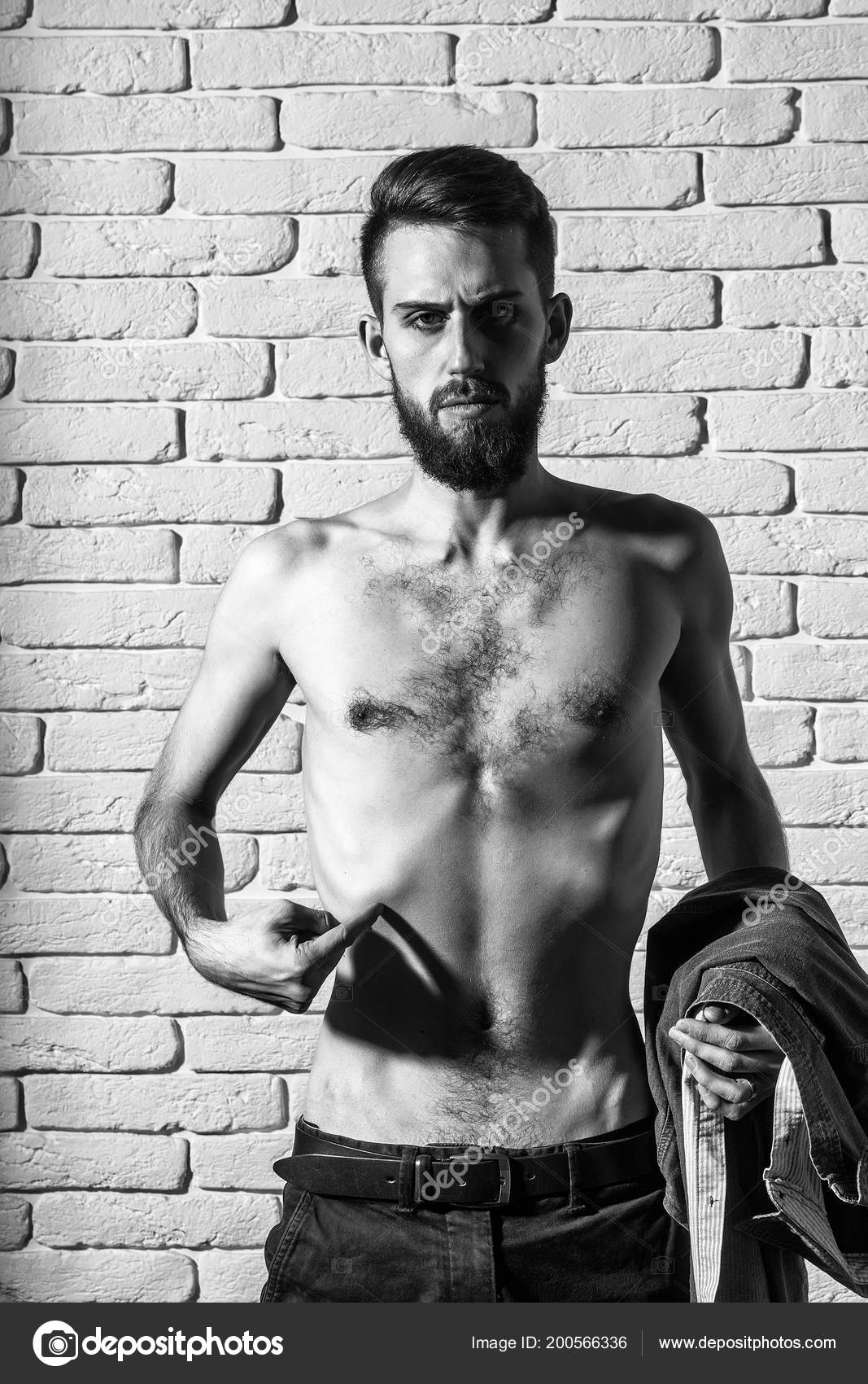 Thin man. slim bearded man with thin bare torso on brick background ...