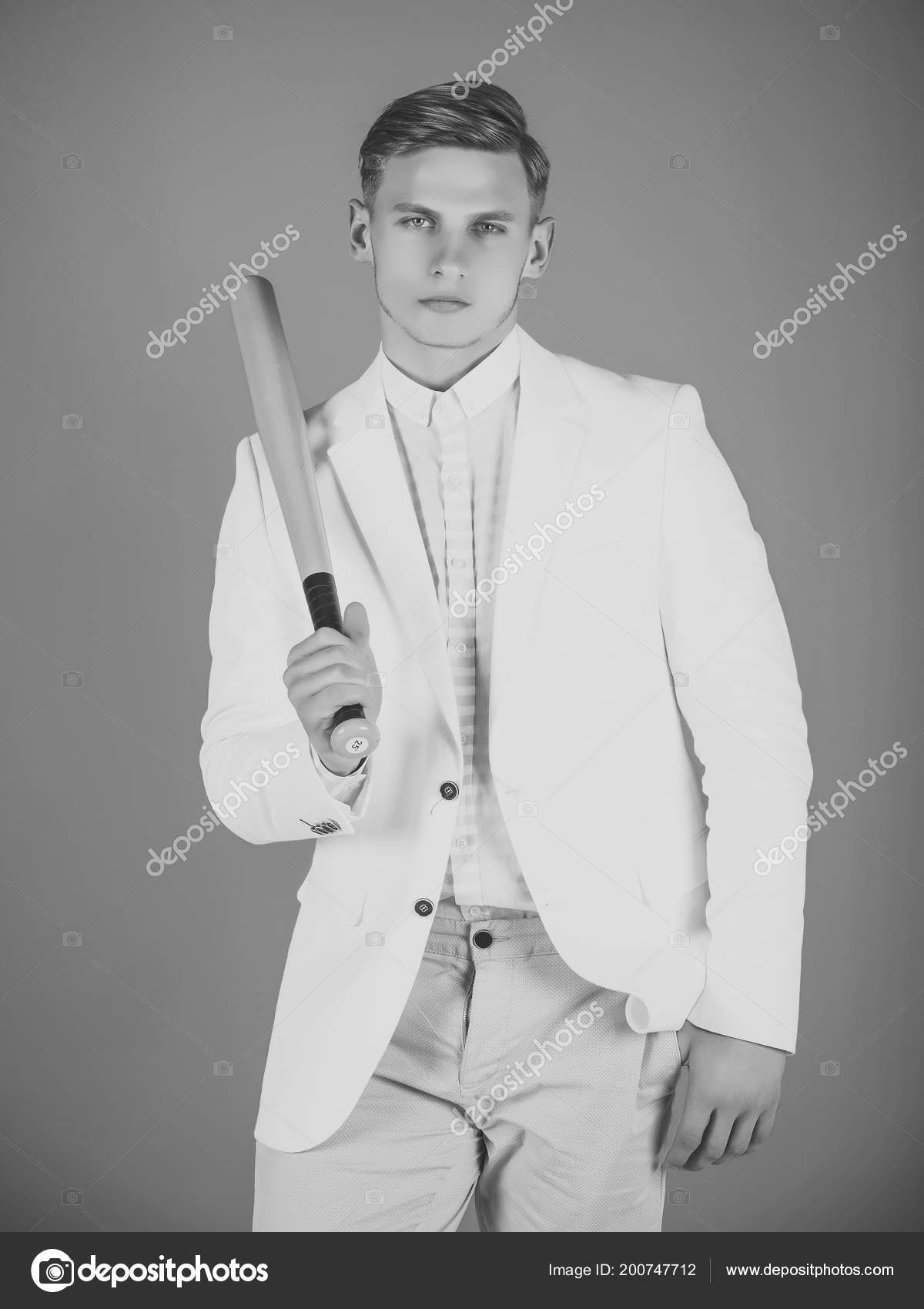 Man with a baseball bat. Baseball player posing on blue background ...