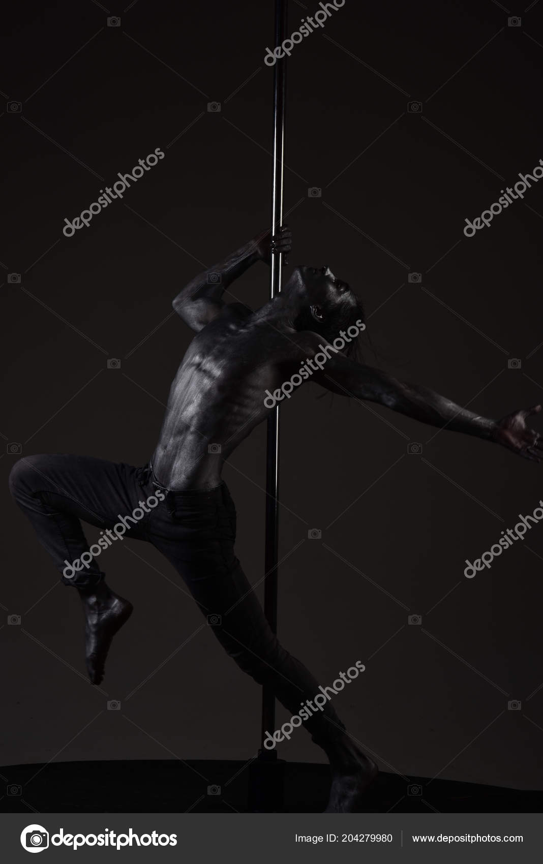 Pole dance sport. Muscular man with silver body art dancing on pylon ...