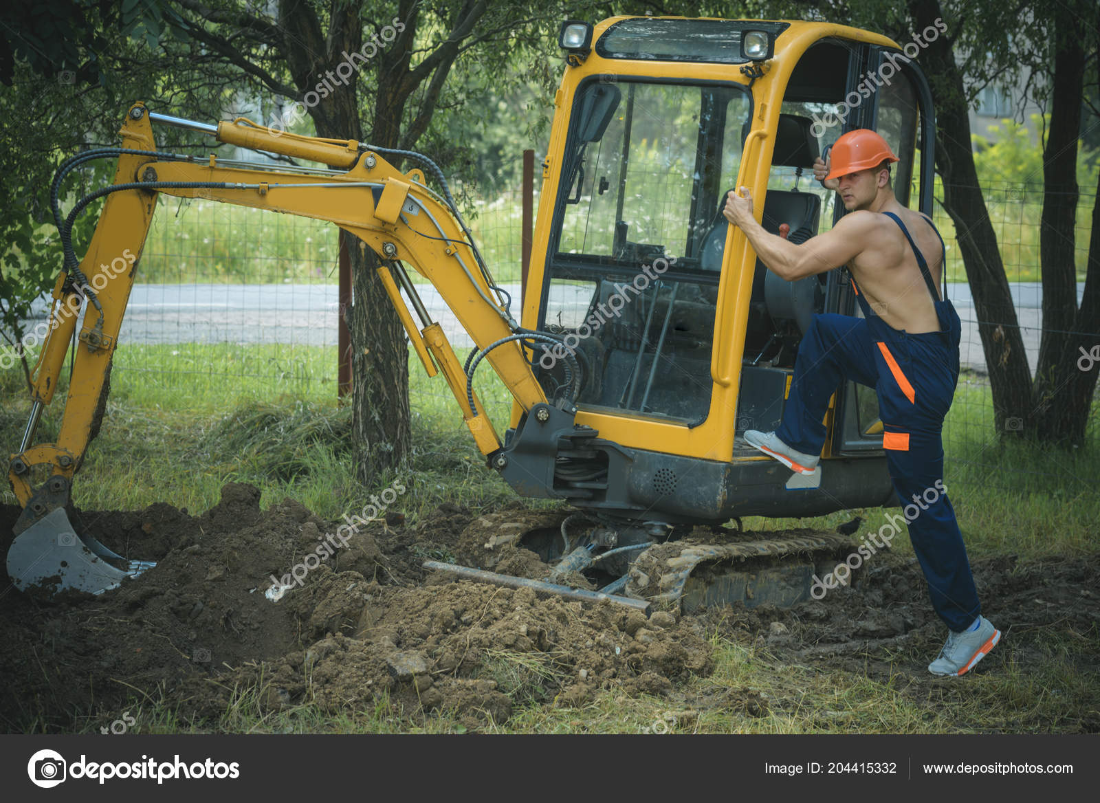 Earthwork concept. Earthwork operator at excavator. Man climb on digger ...