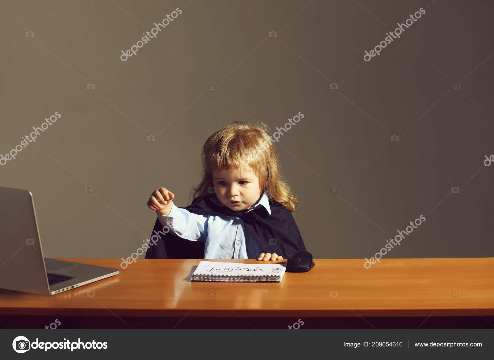Little boy at school desk Stock Photo by ©Tverdohlib.com 209654616