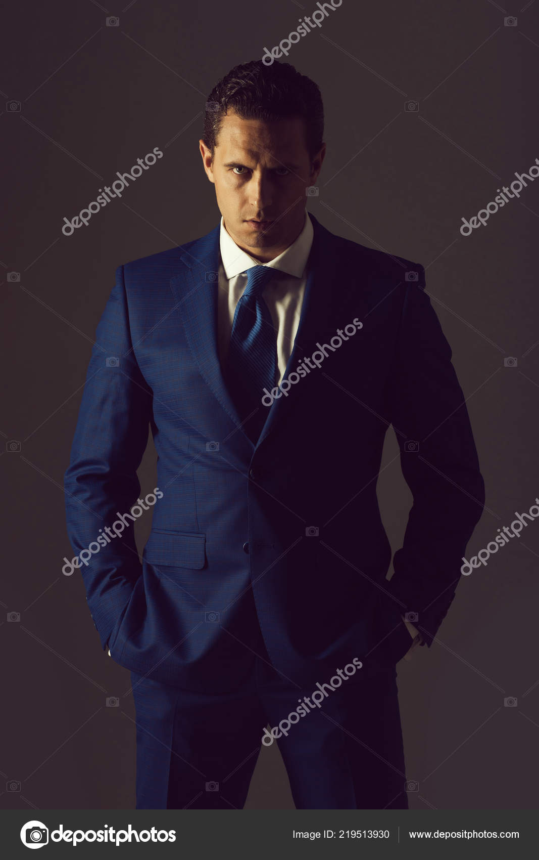Man with serious face and stylish hair in suit Stock Photo by ...