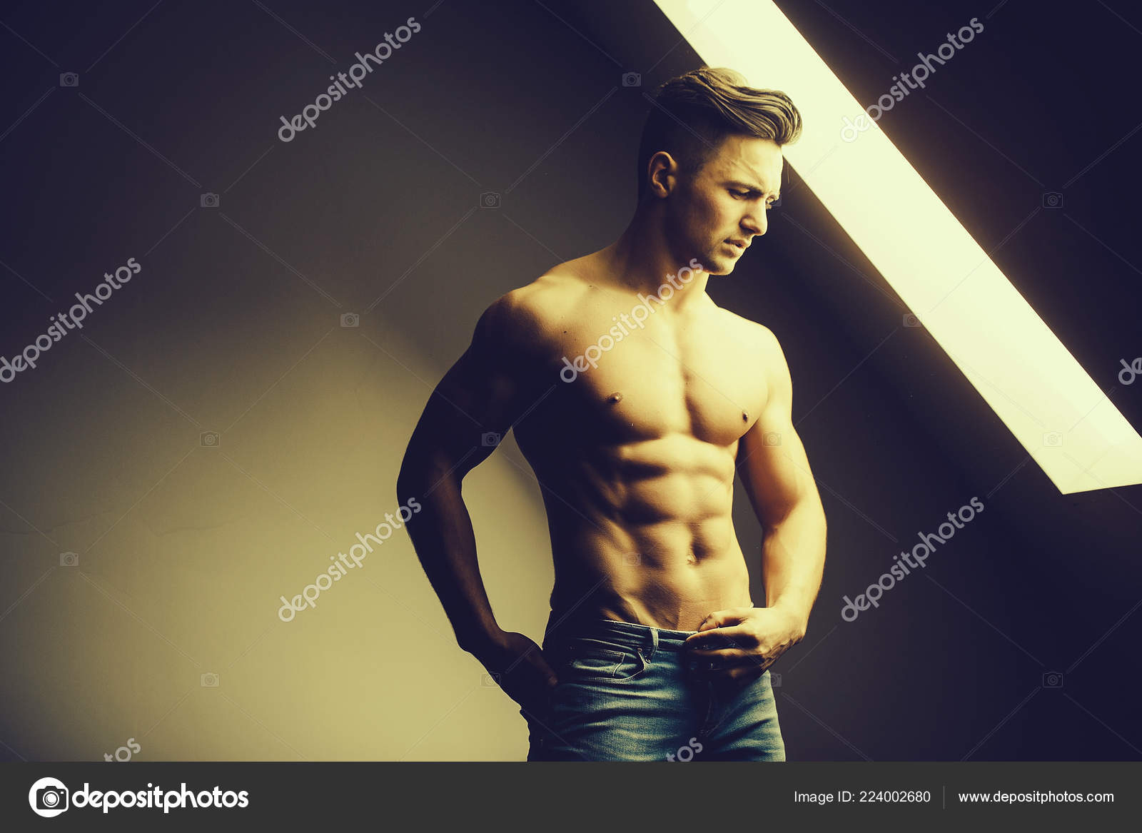 Muscular man near window Stock Photo by ©Tverdohlib.com 224002680