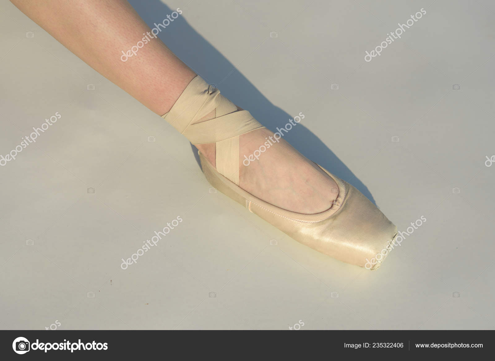 Toe dancing. Ballerina leg in white ballet shoe. Lacing ballet slipper ...