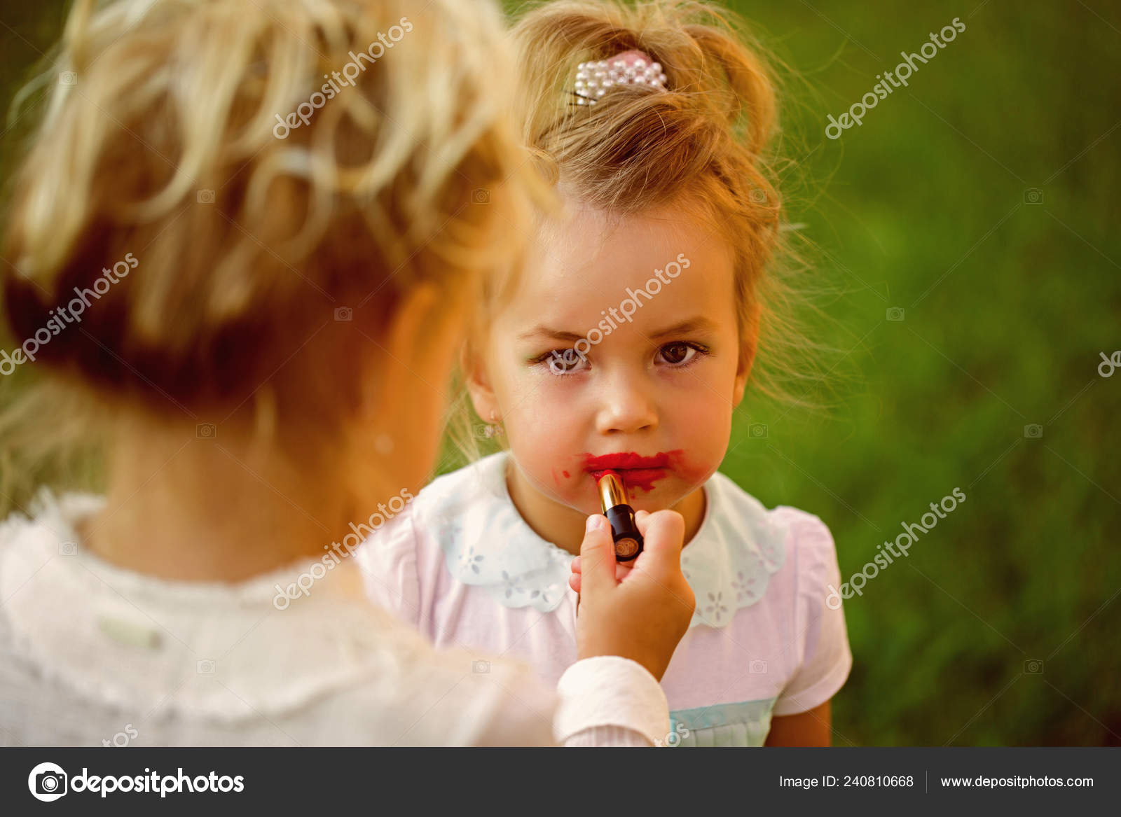 Baby apply red lipstick on lips of kid model — Stock Photo © Tverdohlib ...