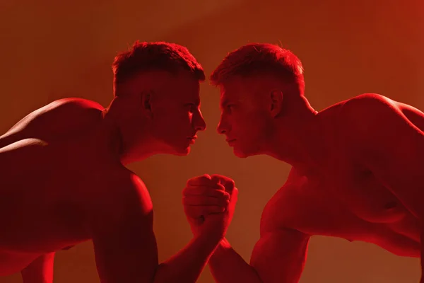 Strength skills. Twins men competing till victory. Twins competitors ...