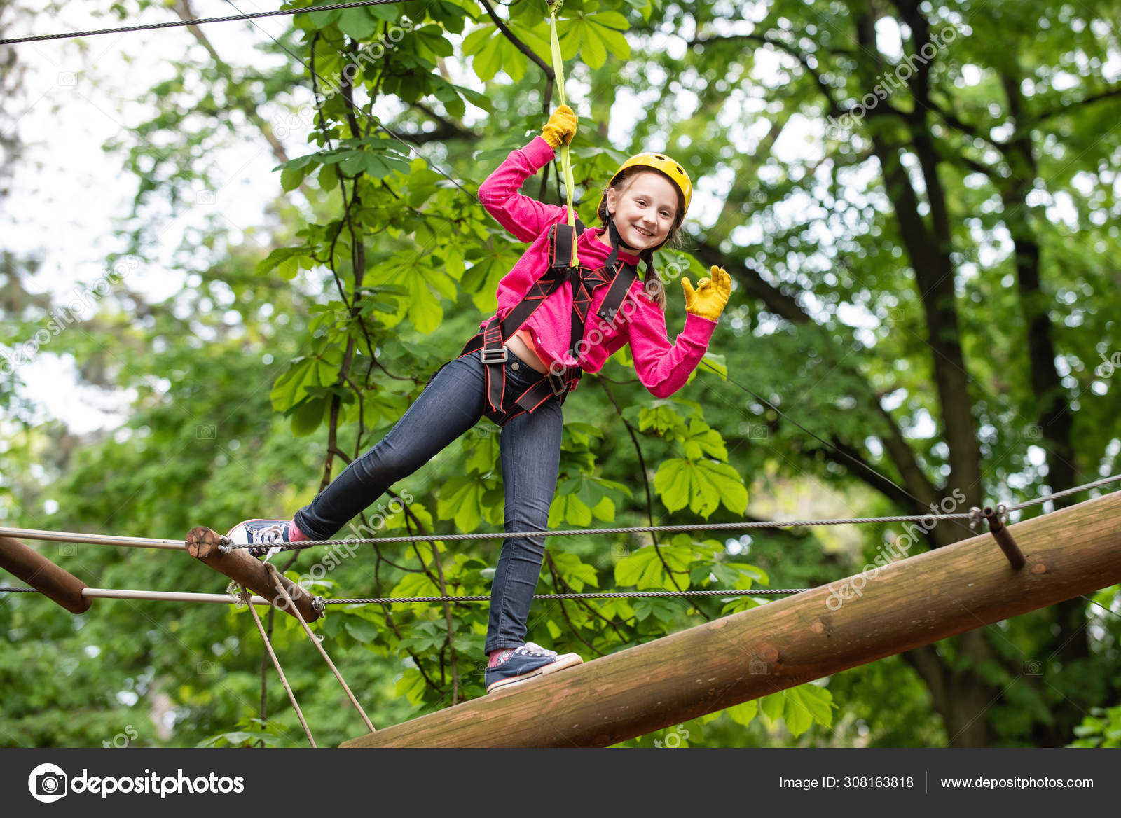 Happy little child climbing on a rope playground outdoor. Carefree ...