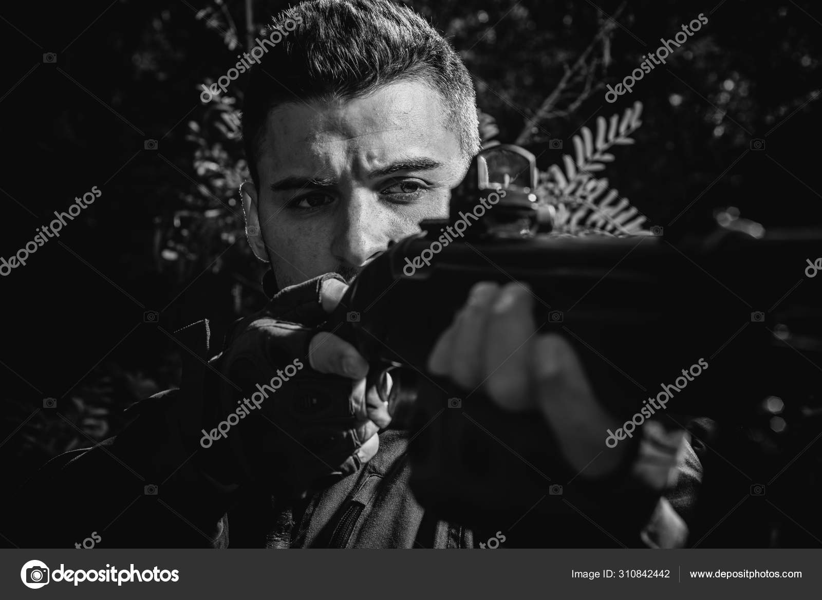 Hunter with shotgun gun on hunt. Hunter Target with laser sight ...