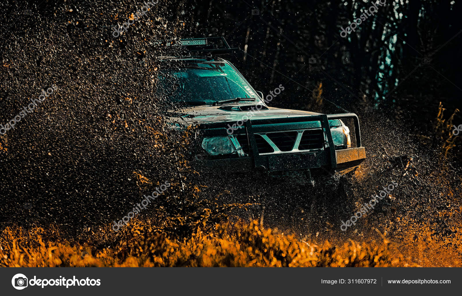 Mud and water splash in off-road racing. Drag racing car burns rubber ...