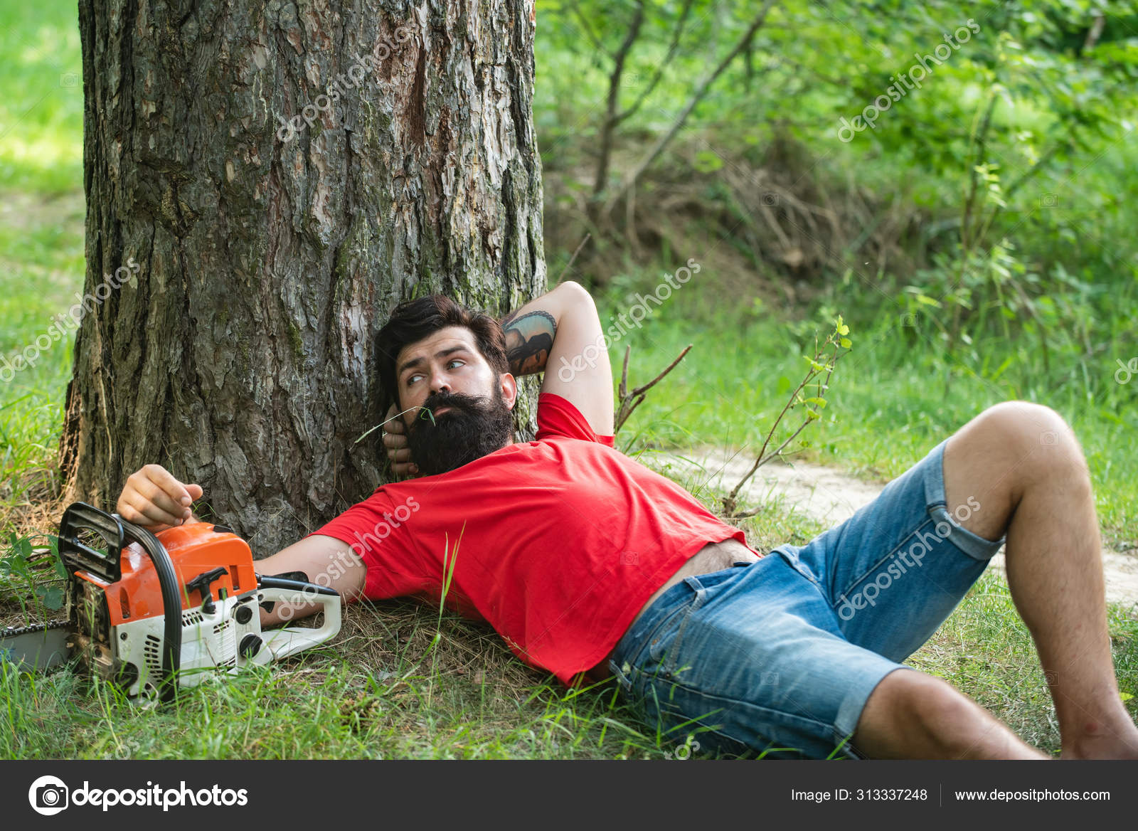Resting after hard work. Lumberjack worker with chainsaw in the forest ...