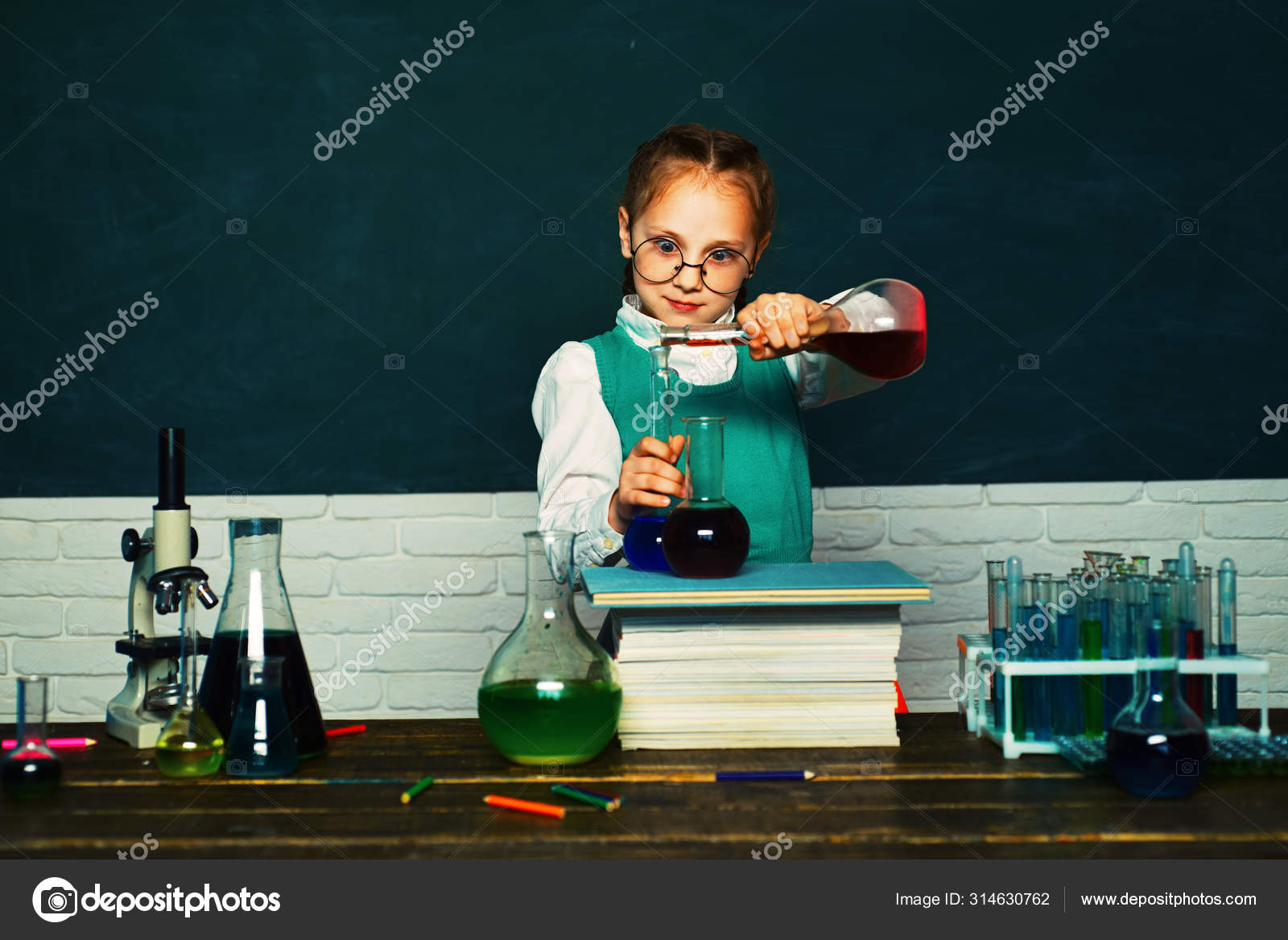 Lab microscope and testing tubes. Child in the class room with ...