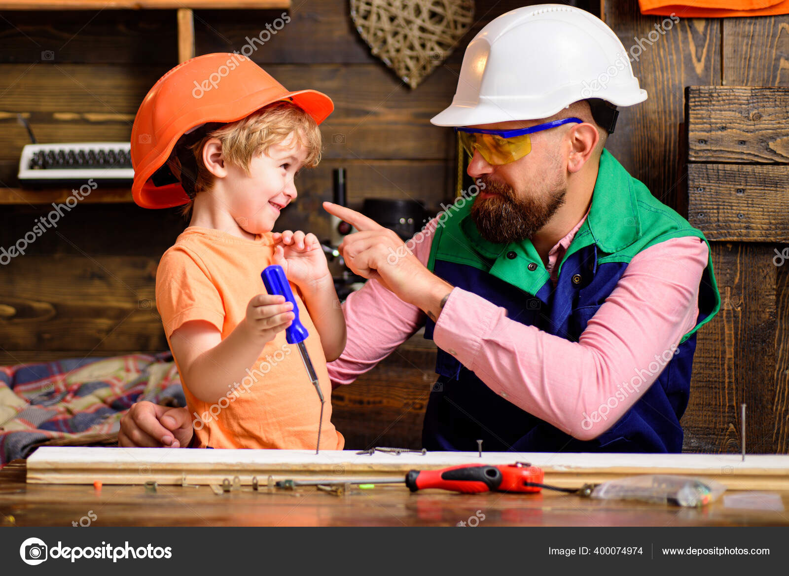 Tools construction. Father teaching little son to use carpenter tools ...