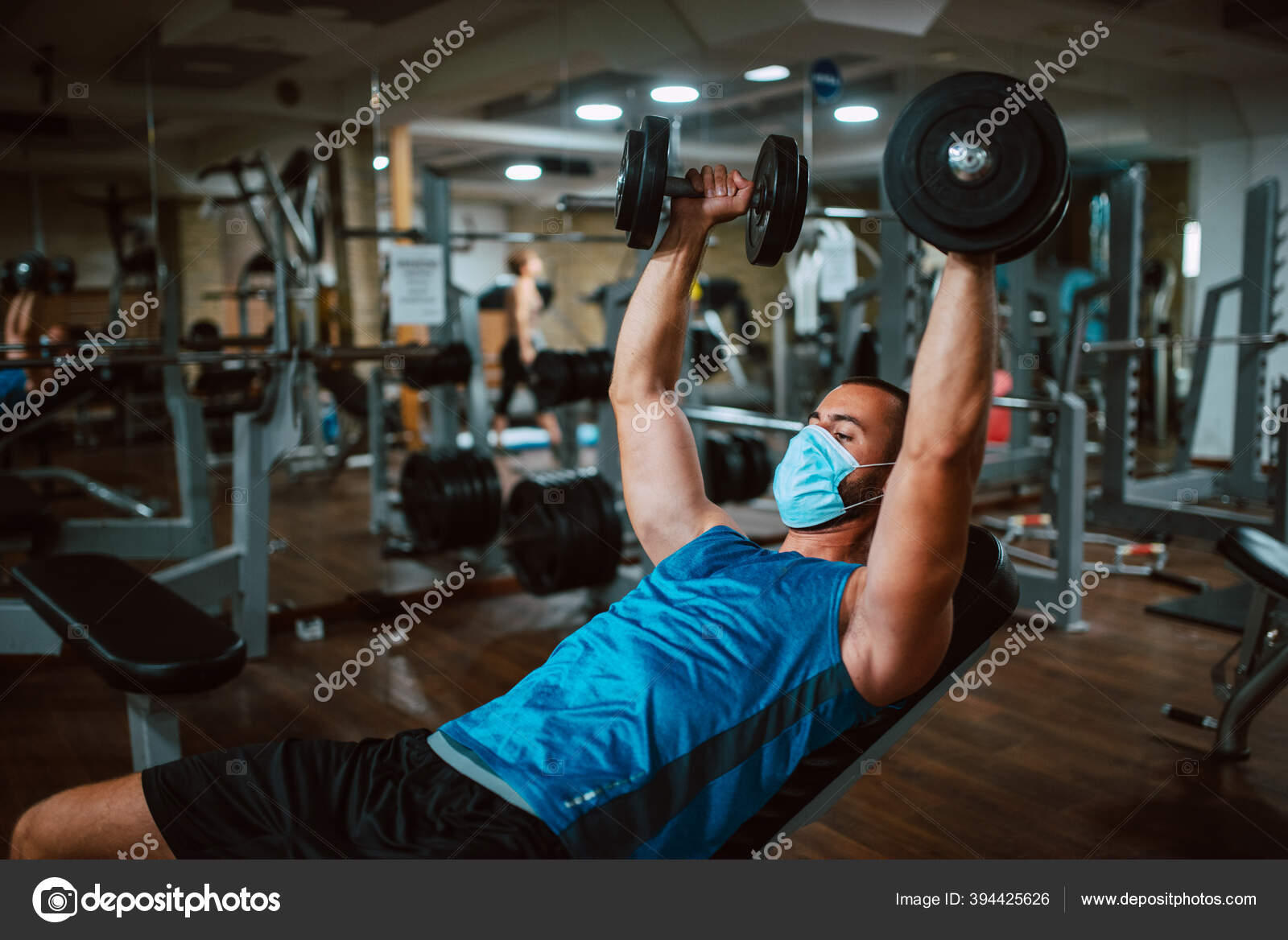 Young Caucasian Athlete Man Mask His Face Exercises Lifts Weights Stock ...