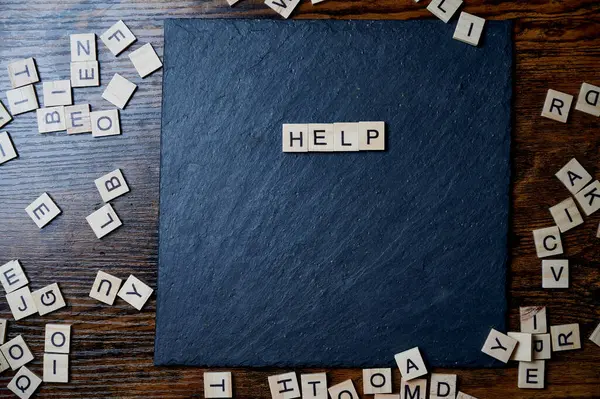help message written with wooden letters on slate stone - Stock Image ...
