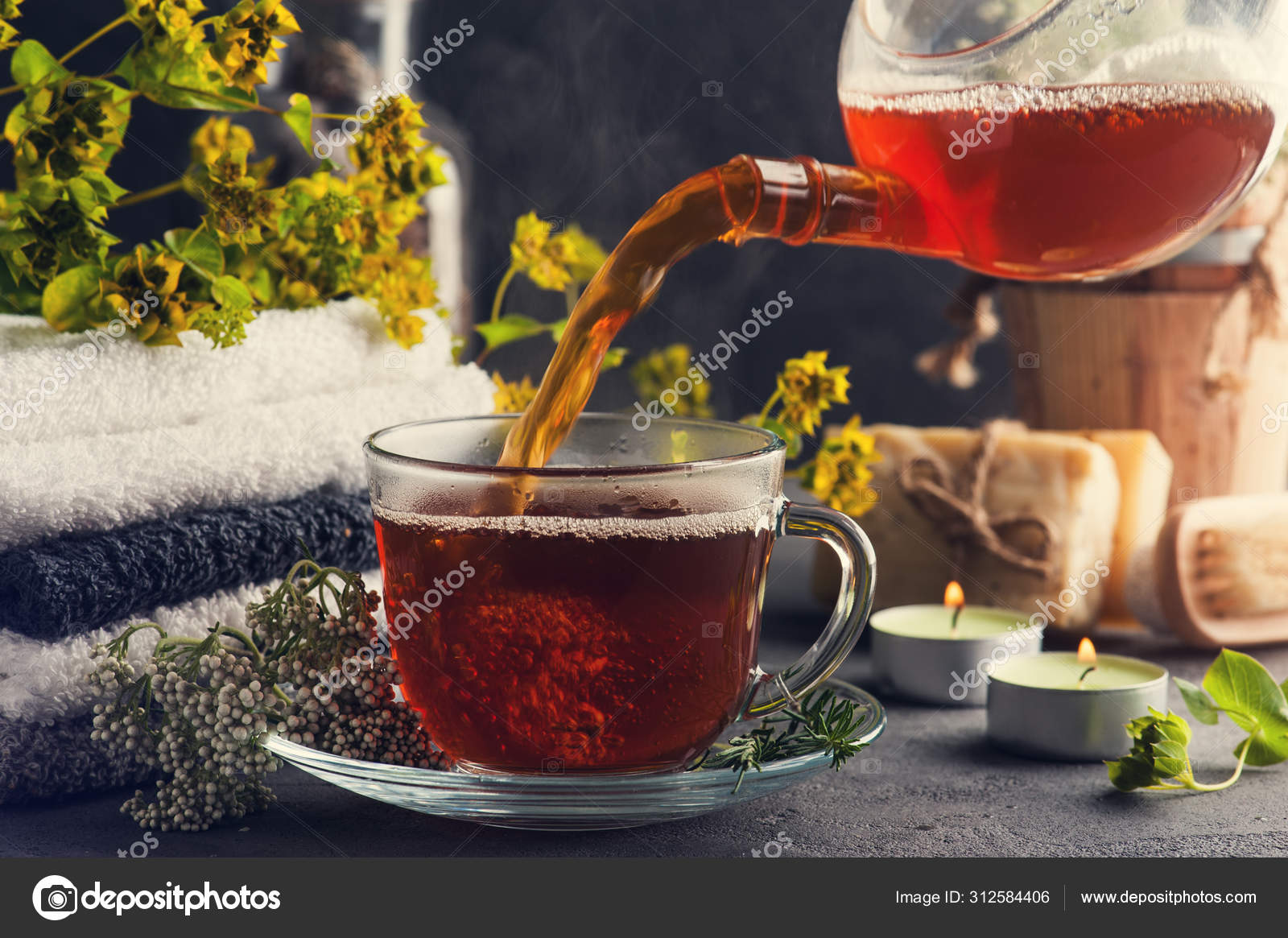 Cup of tea and lit candles Stock Photo by ©irinabort 312584406