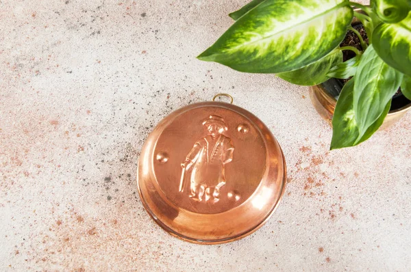 Vintage copper cookie mold on a concrete background. Copy space for ...