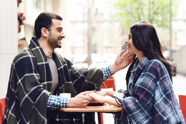 Loving couple in rugs sits at table. Romantic concept - Stock Image ...