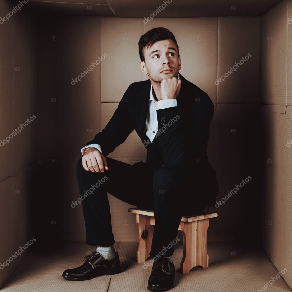 Joven Empresario en Traje Negro en Caja de Cartón. Joven de traje. La ...