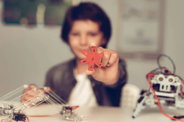 Concentrated boy creating robot at lab. Stock Photo by ©ijeab 309115636