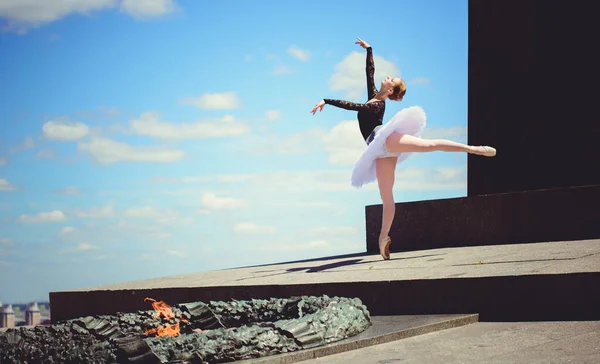 Young woman in white tutu dancing in the green landscape. Beautiful ...