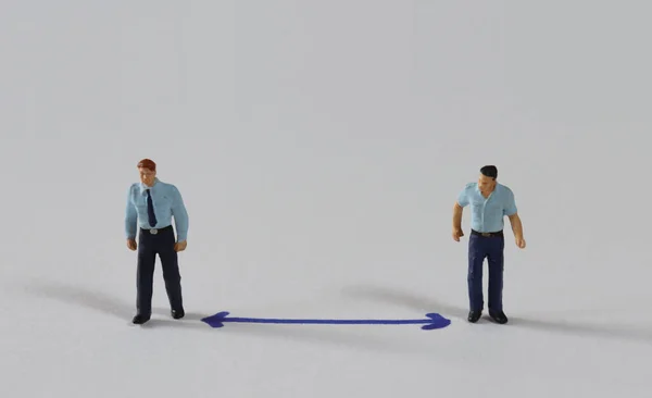 The concept of social distancing. Miniature people standing at a ...
