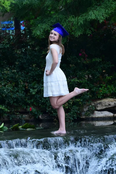 Young Female High School Senior posing for Senior photos in a beautiful ...