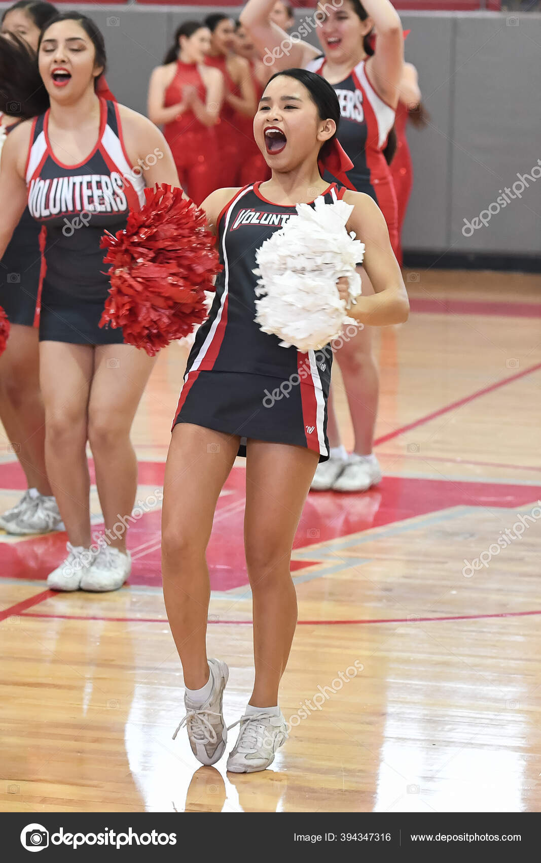 Cute Asian American Cheerleader Performing High School Football Game