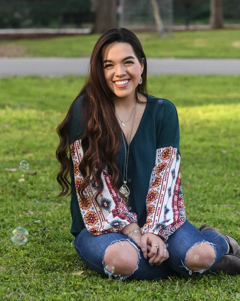 Young Female High School Senior posing for Senior photos in a beautiful ...