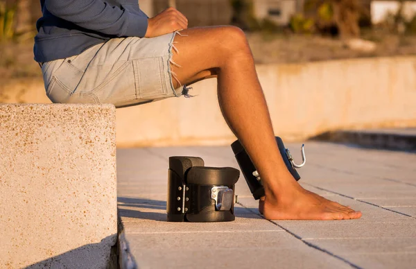 Man putting on anti gravity or inversion boots for upside down hanging ...