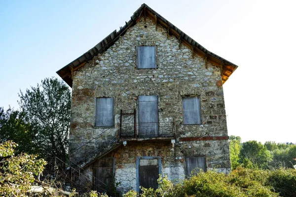 Old abandoned house made of rocks in a village. - Stock Image - Everypixel