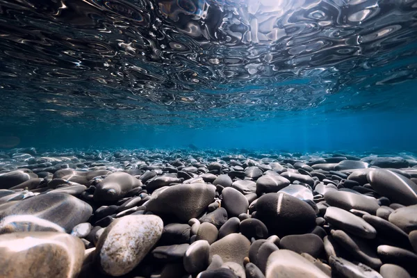 Underwater sea with stones, reflection and blue water. Ocean texture ...