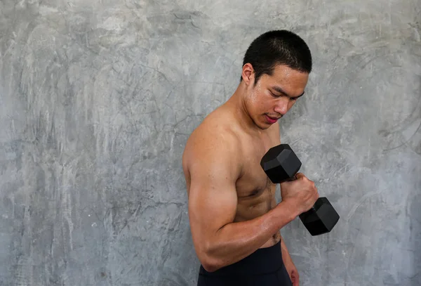 Asian men are playing dumbbells to build muscle. Muscular man ...