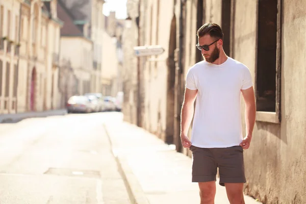 Hipster handsome male model with beard wearing white blank t-shirt with ... Hipster handsome male model with beard wearing white blank t-shirt with ...