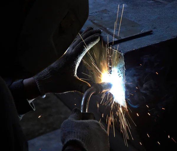 welder makes a velding metal structure in a workshop sparks - Stock ...