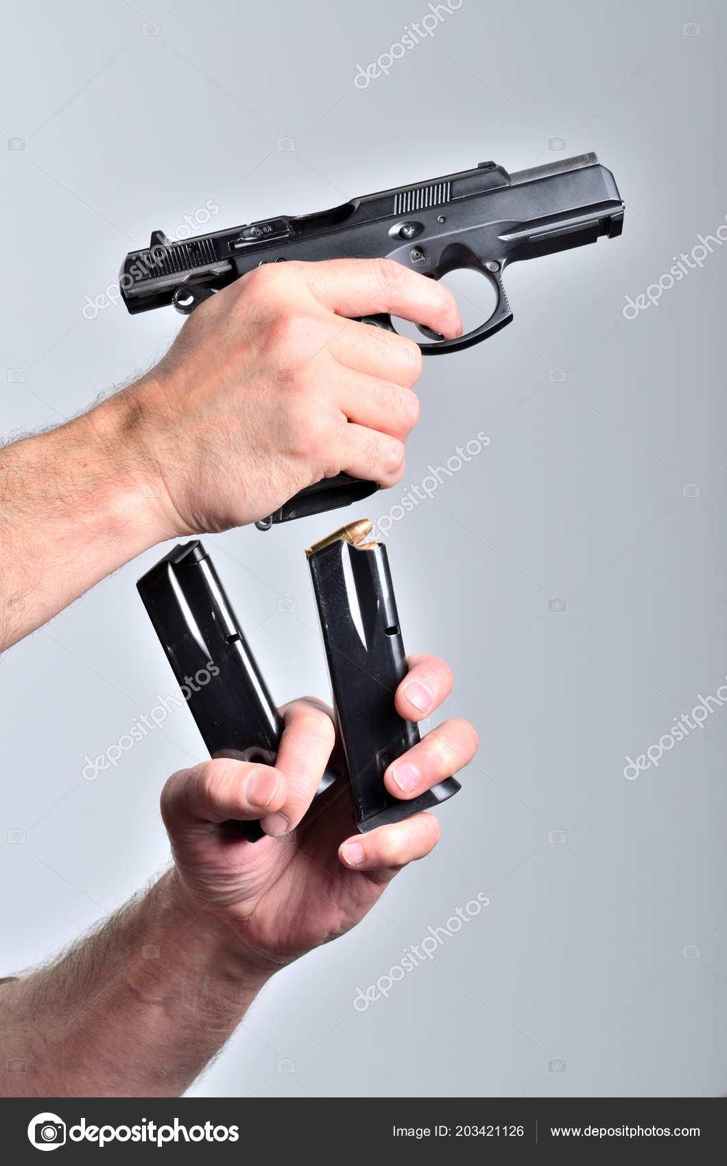 Man reloading pistol gun after shooting isolated vertical photo Stock ...