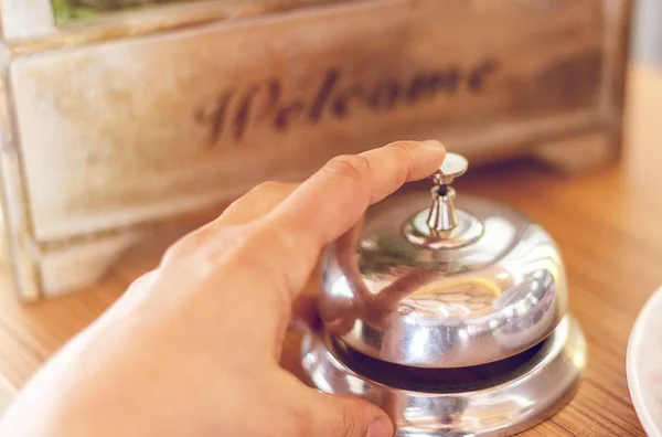 Hand ringing in service bell at hotel - Stock Image - Everypixel