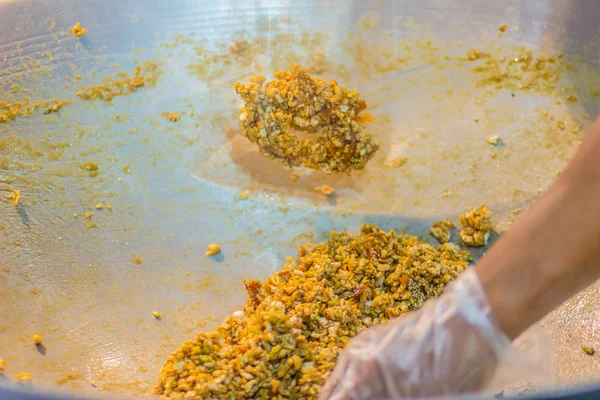 Close up hand of Thai vendor while cooking sweet Krayasat, a Thai ...