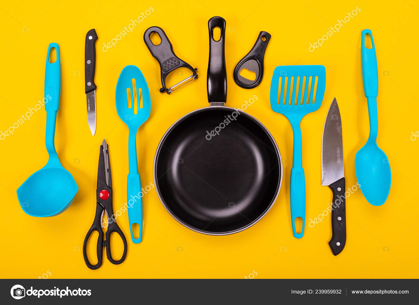 Frying pan with kitchen utensils isolated on yellow background Stock ...