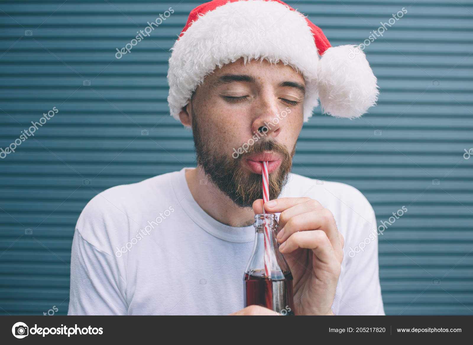 Portrait Of Bearded Man Standing And Drinking Coke Through Plastic Straw He Is Keeping Eyes