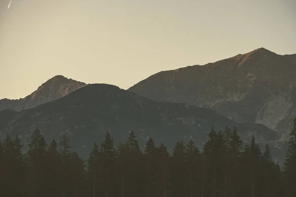 morning light rising over hill tops and forests in mountains Tatra in ...