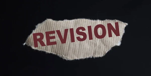 The revision text is written on a piece of paper and on a black ...