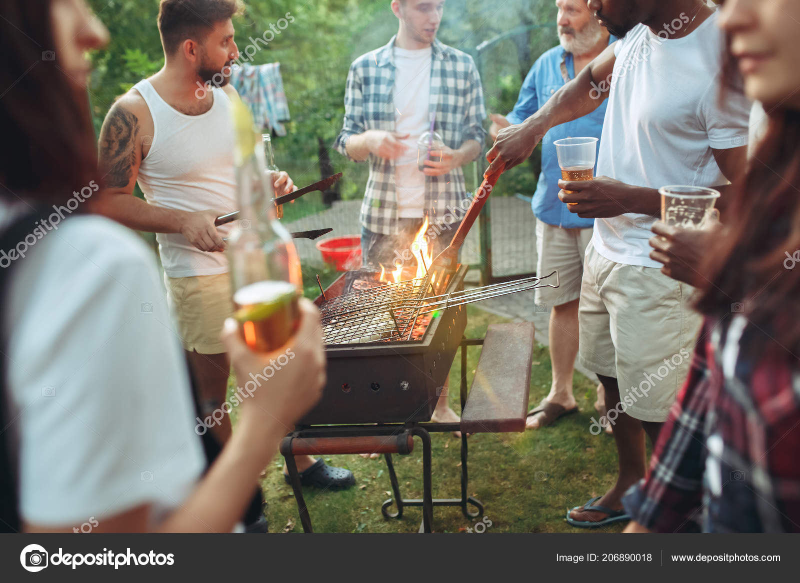 Group of friends making barbecue in the backyard. concept about good ...