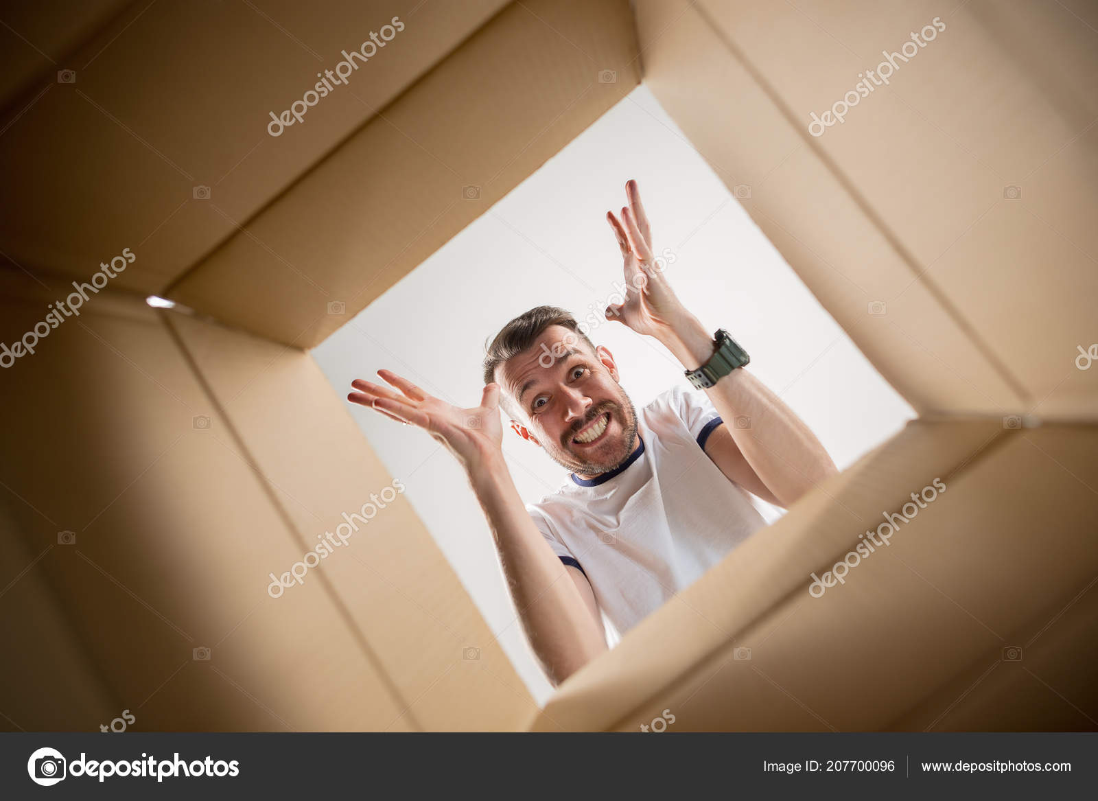 Man unpacking and opening carton box and looking inside — Stock Photo ...