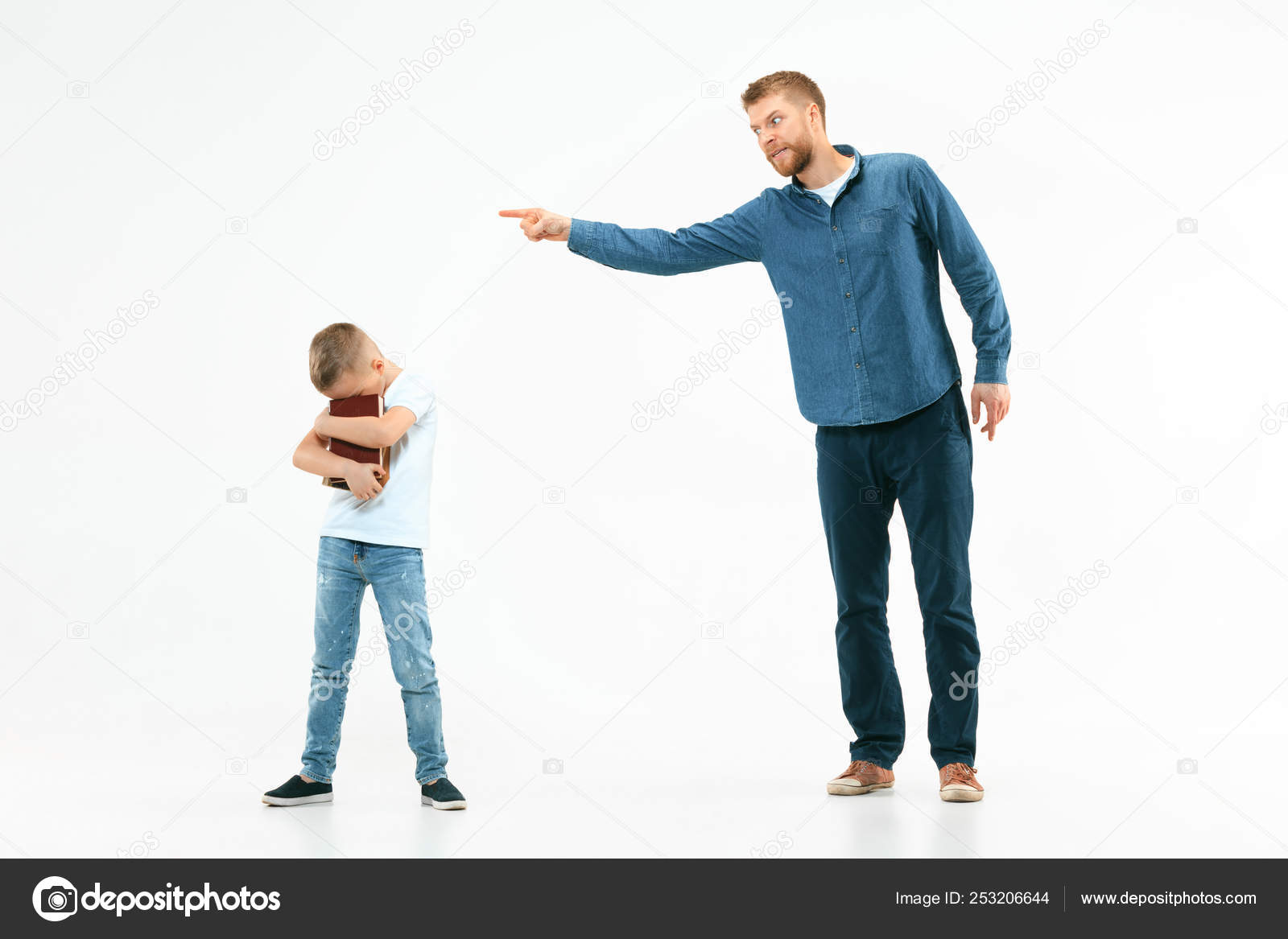 Angry father scolding his son in living room at home Stock Photo by ...
