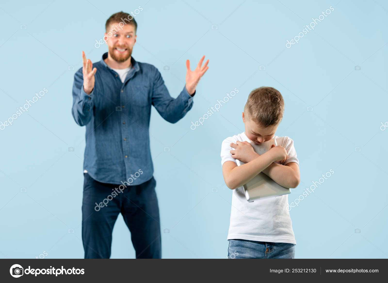 Angry father scolding his son in living room at home Stock Photo by ...