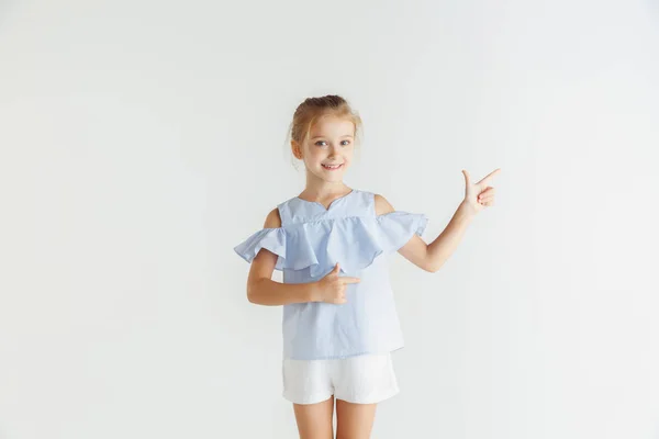 Little smiling girl posing in dress on white studio background Stock ...