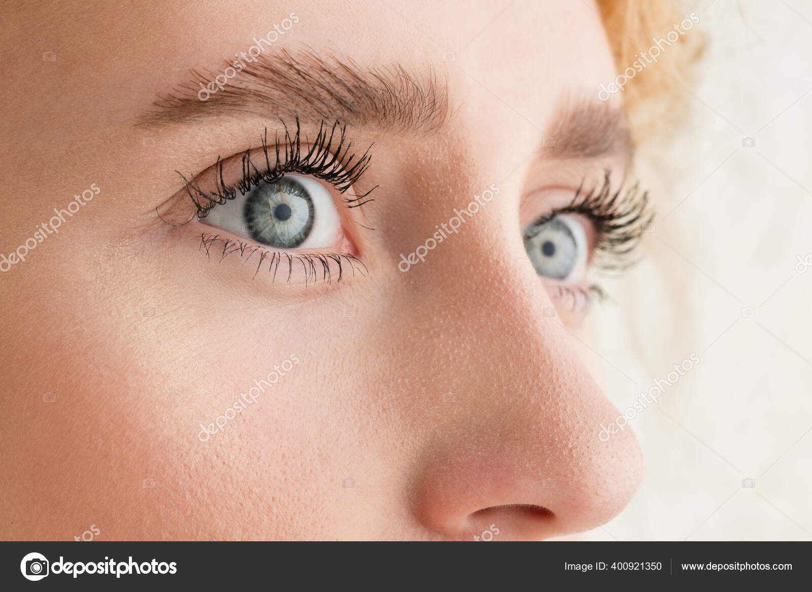 Close up of face of beautiful caucasian young woman, focus on eyes ...